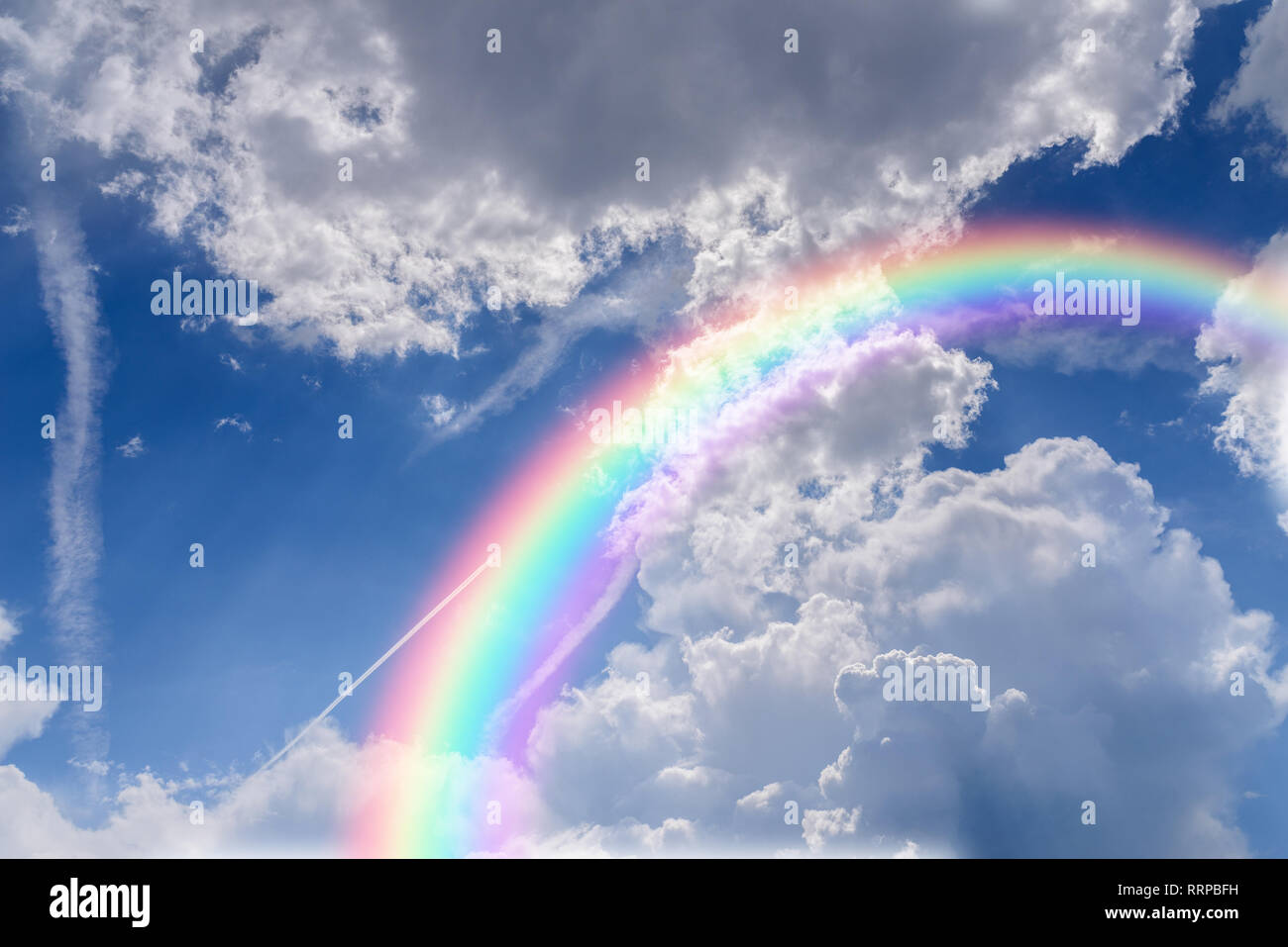 Colorful rainbow in clouds - beauty in nature concept Stock Photo - Alamy