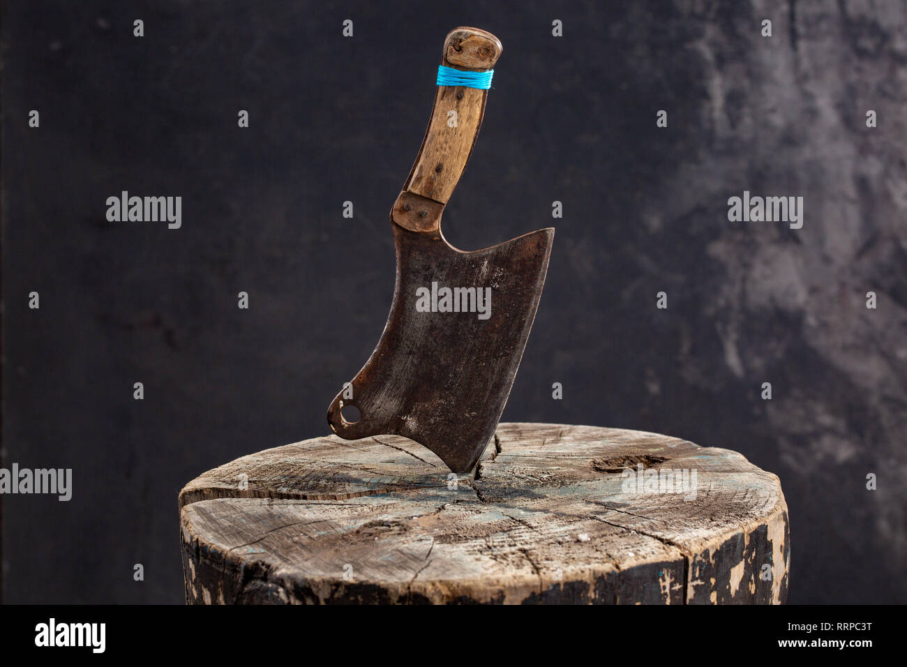 meat axe on a wooden stump or deck on black background Stock Photo - Alamy