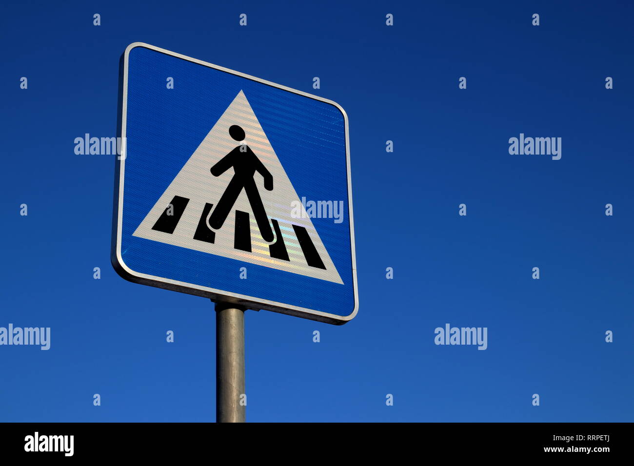 Blue traffic sign on blue sky Stock Photo - Alamy