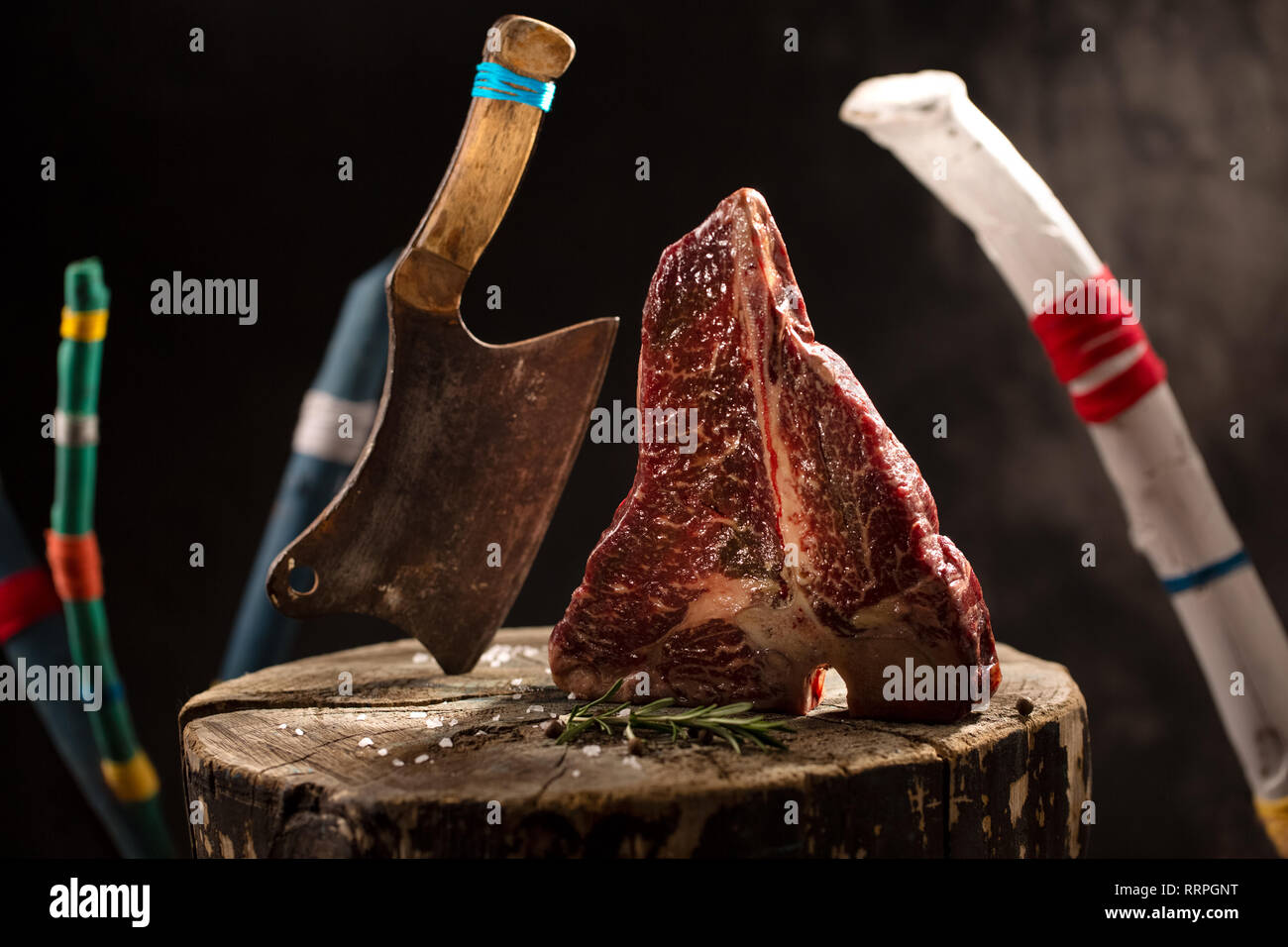 Raw Fresh Marbled Meat Beef ax on a stump on black background Stock ...