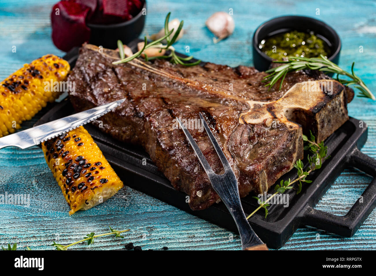 The Medium rare grilled Steak Ribeye Black Angus with corn and rosemary ...