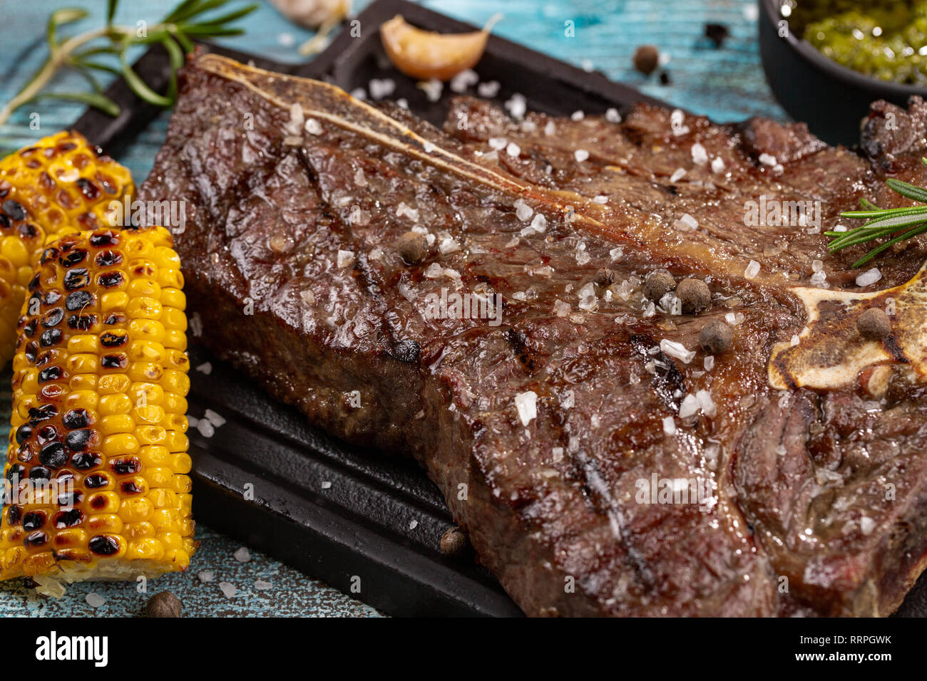 The Medium rare grilled Steak Ribeye Black Angus with corn and rosemary ...