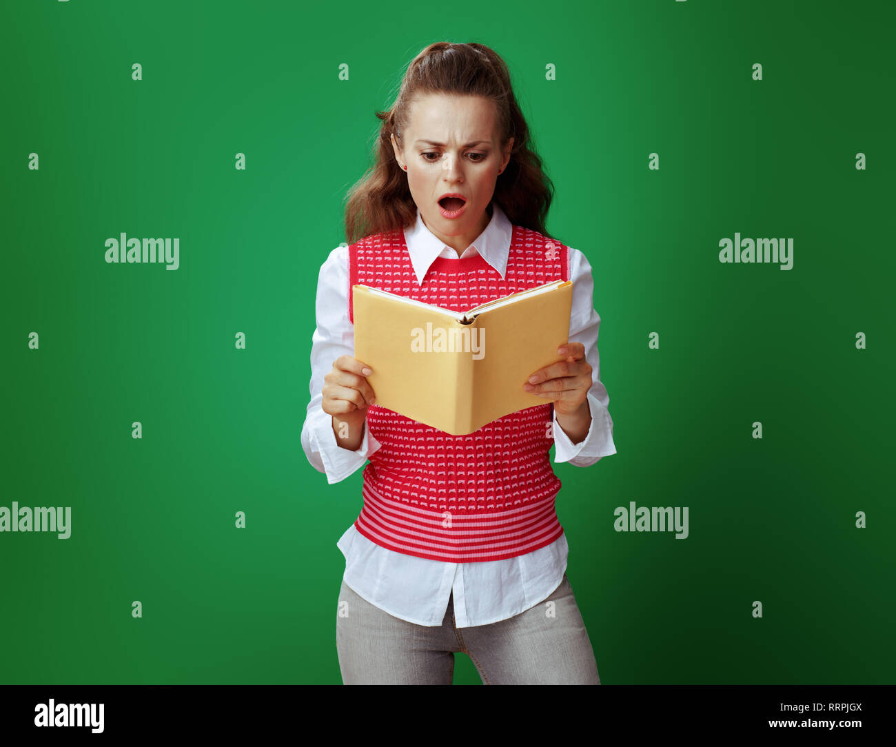 Woman shock reading book library hi-res stock photography and images ...