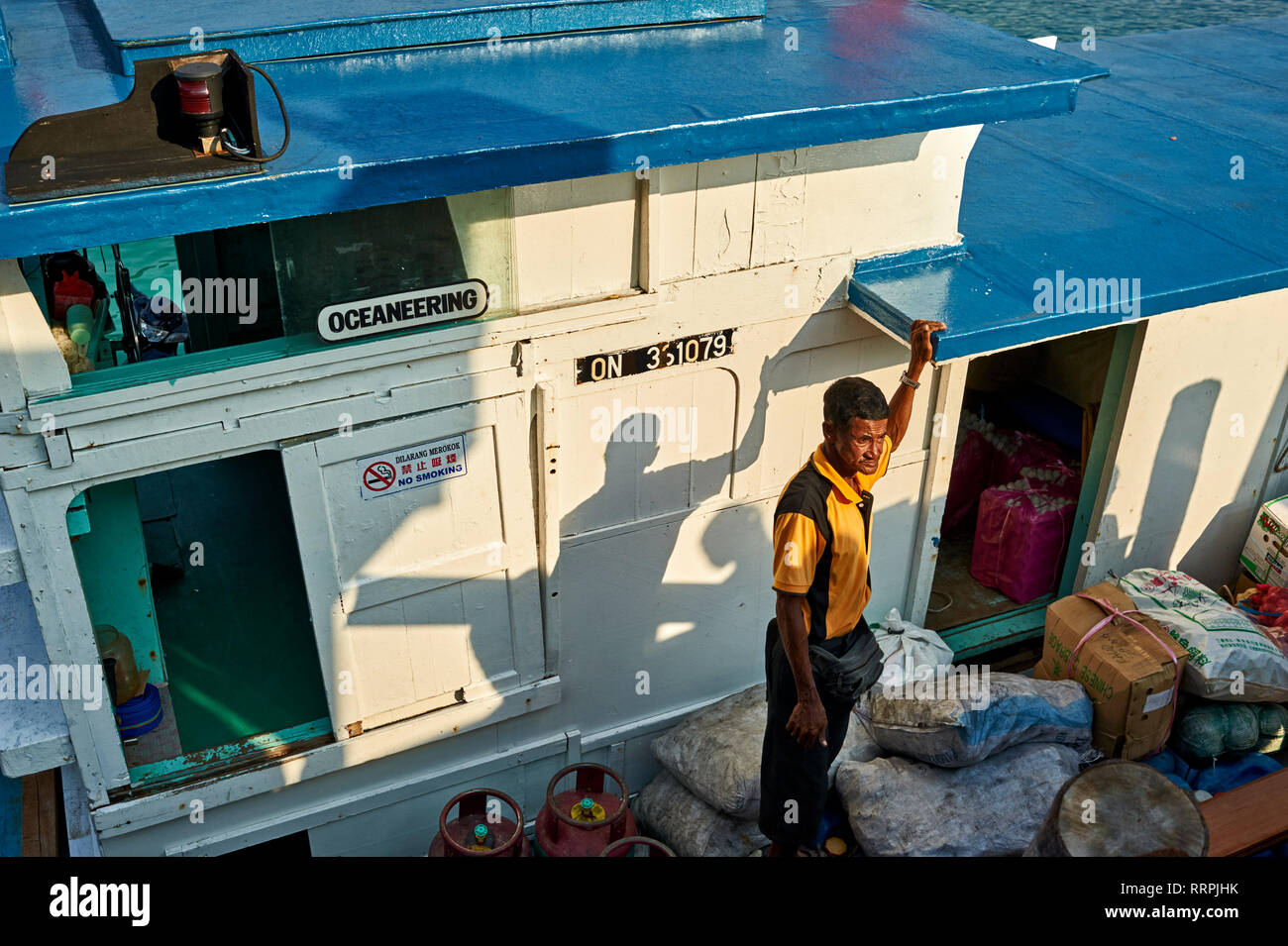 unloading of the supply boat from the end of the Panuba jetty in Tioman ...