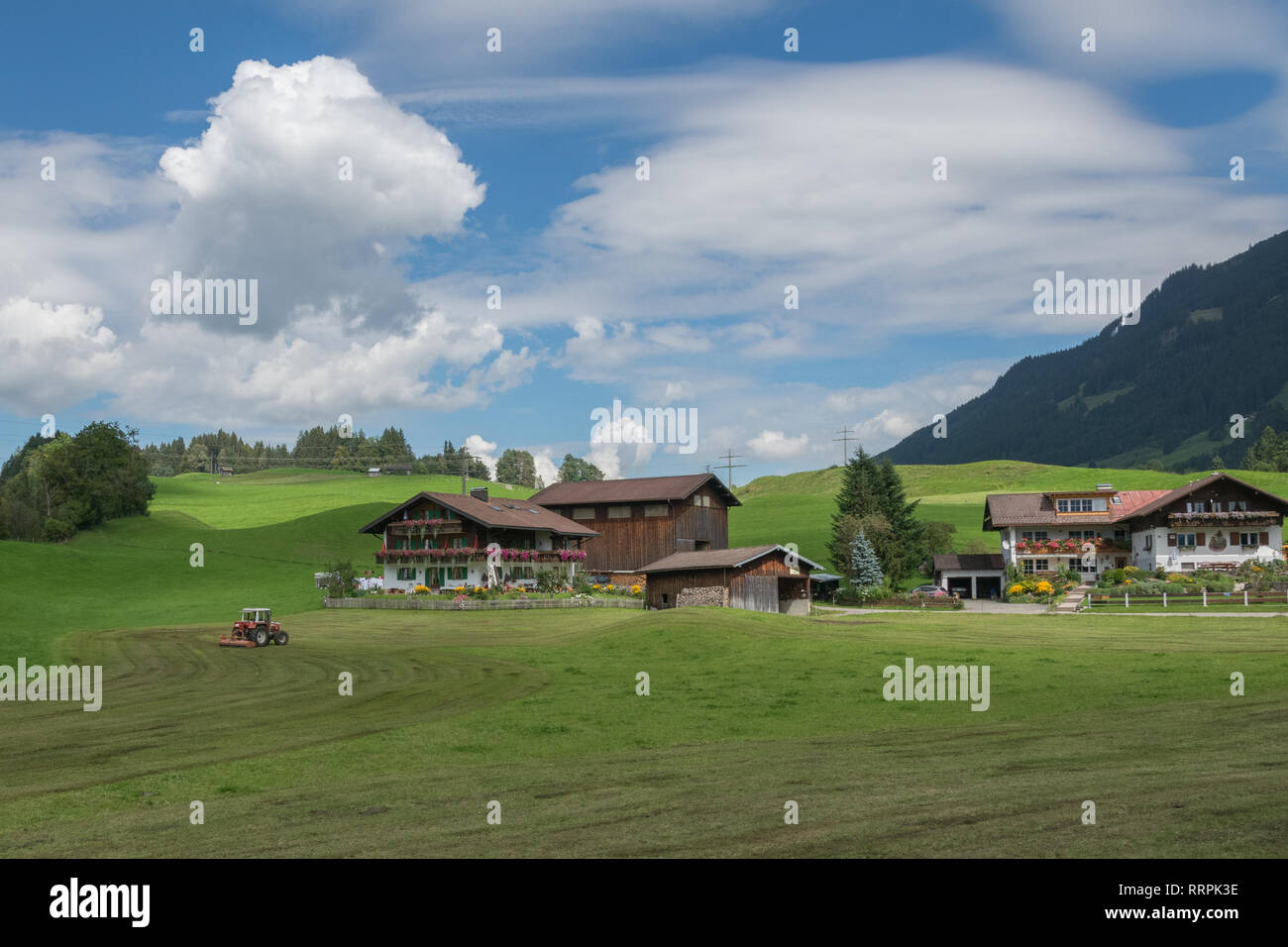 Traditional farm building in the German Alps surrounded by mountains ...