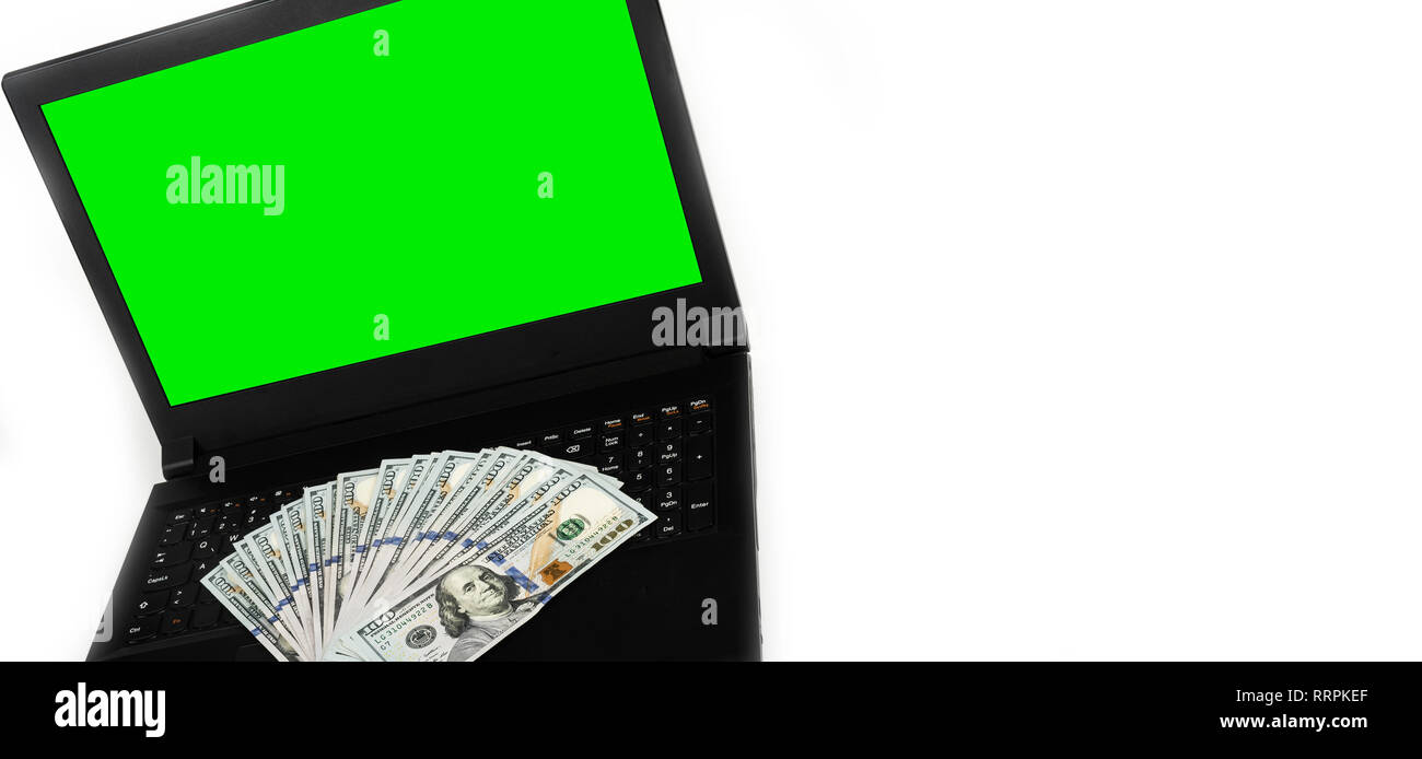 Laptop or notebook with widespread of cash money isolated on white ...