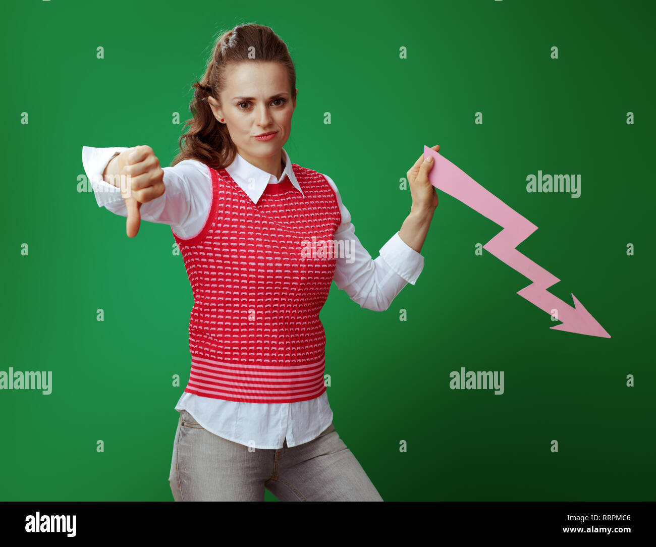 sad fit learner woman in grey jeans and pink sleeveless shirt with ...