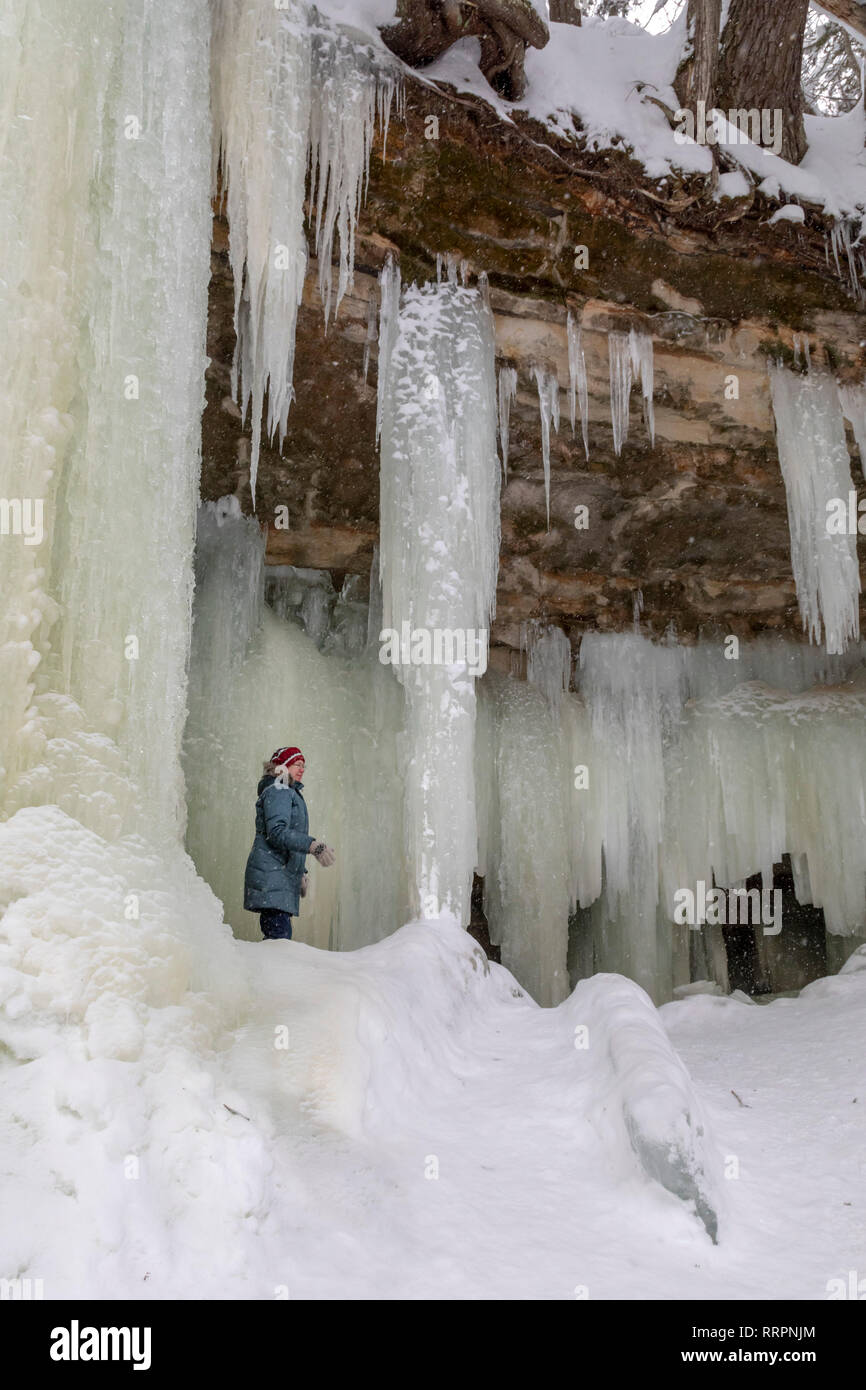 Eben Junction, Michigan - A woman explores the Eben Ice Caves, also ...