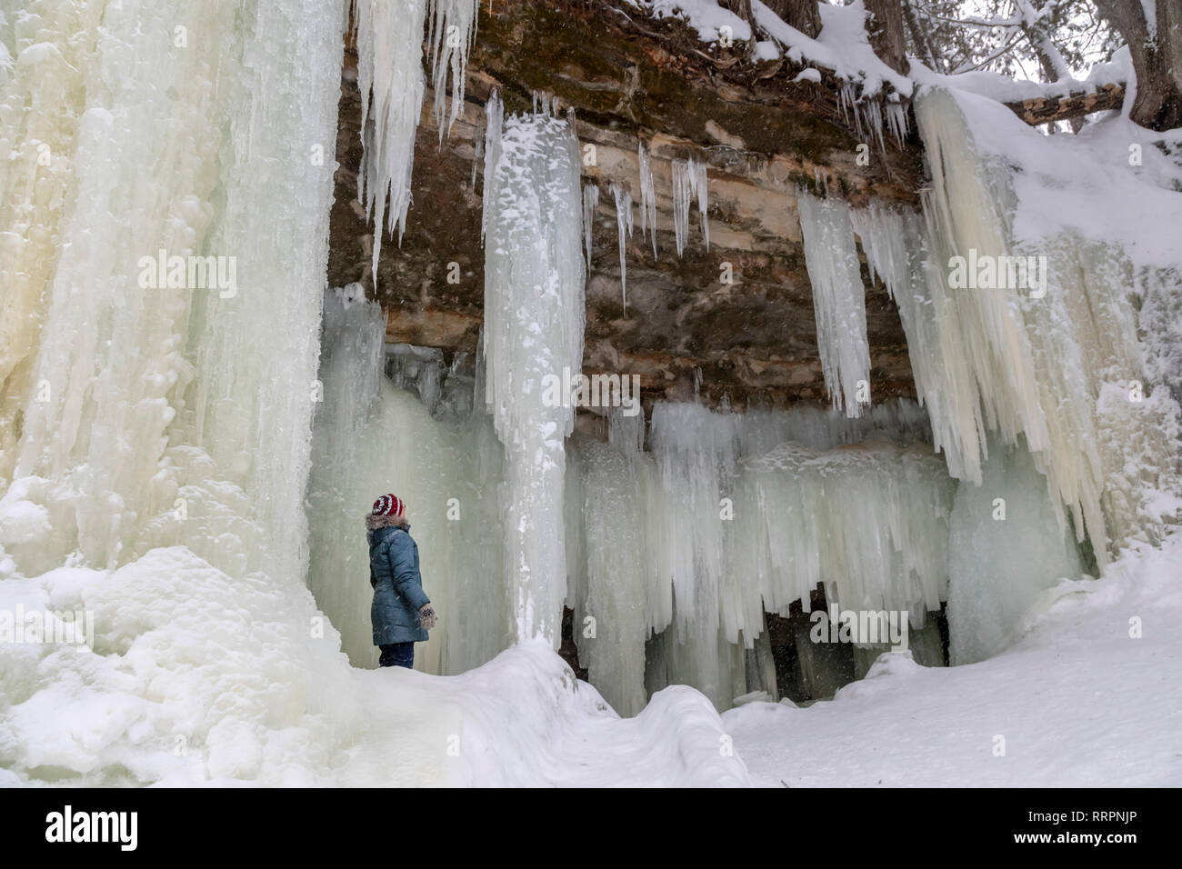 Eben Junction, Michigan - A woman explores the Eben Ice Caves, also ...