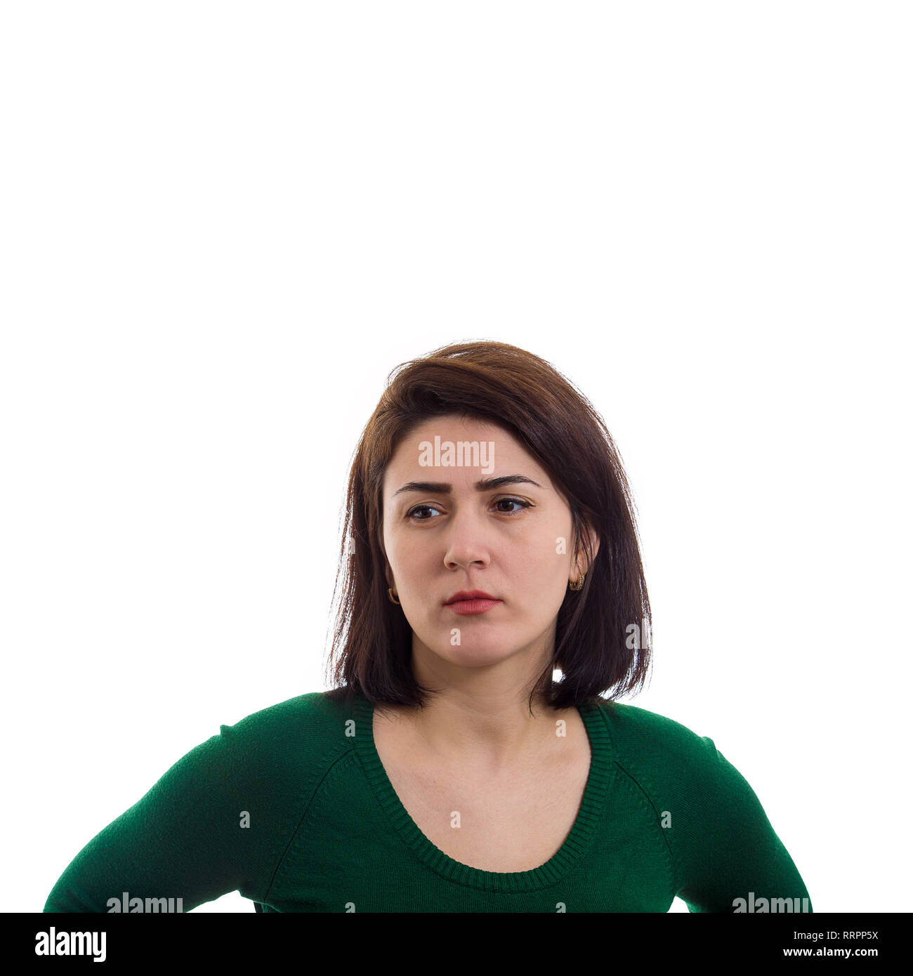 Serious and thoughtful young woman looking sad isolated over white ...