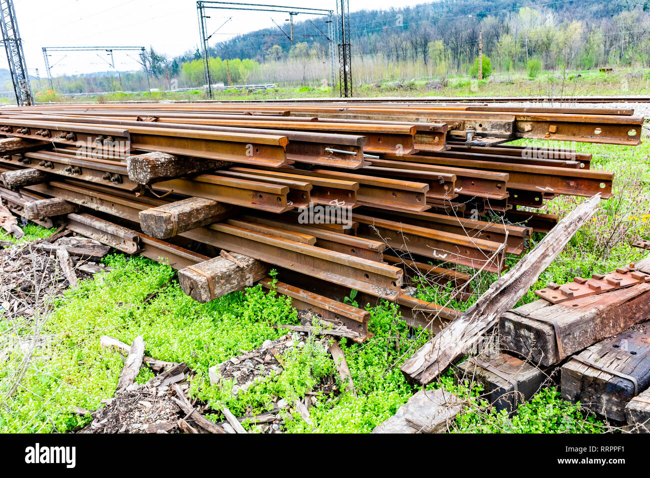 Demounted disassembled old corroded unused railroad tracks and sleepers ...