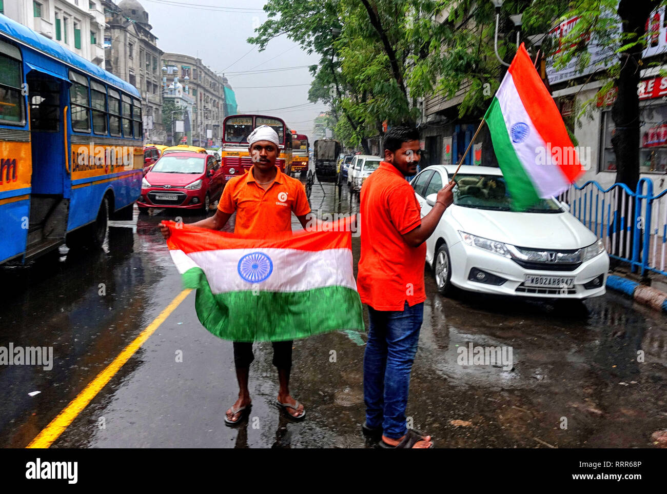 Kolkata, WEST BENGAL, India. 26th Feb, 2019. Two men seen with flags ...