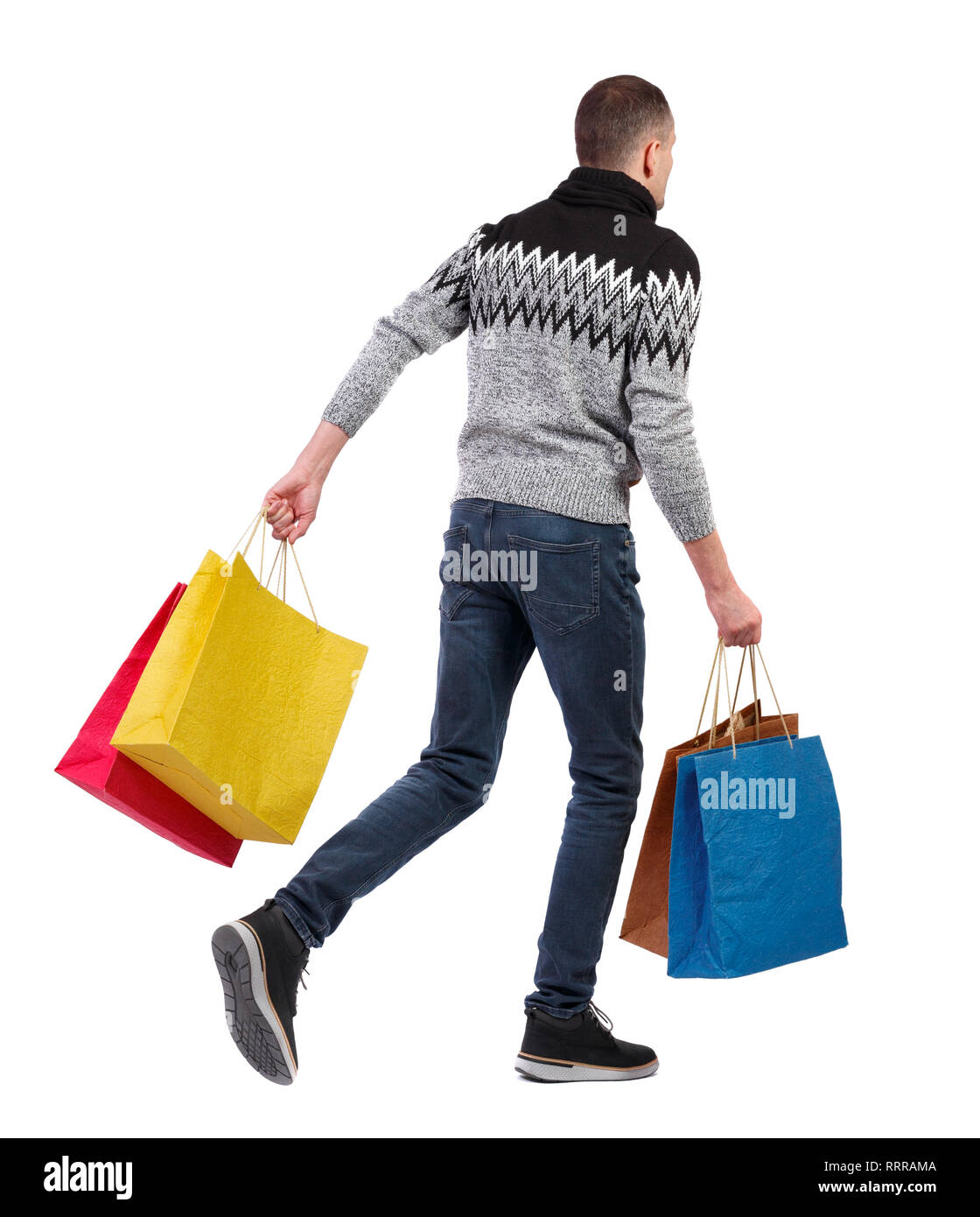 Side view of going man with shopping bags. guy in motion. backside view ...