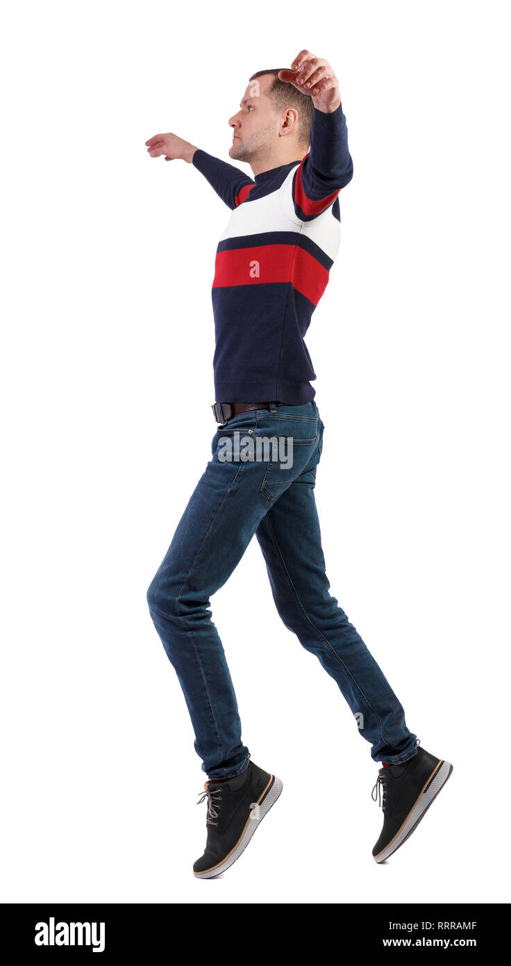 Side view of a man dancing. The guy is balancing. Rear view people ...