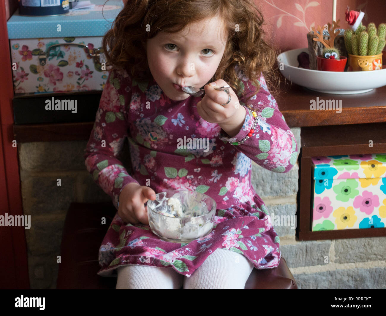 Little Girl Eating Pudding Stock Photo - Alamy