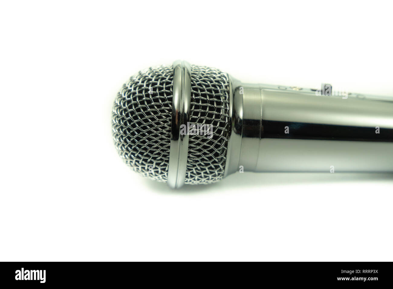 Silver vocal microphone side view close up isolated on a white ...