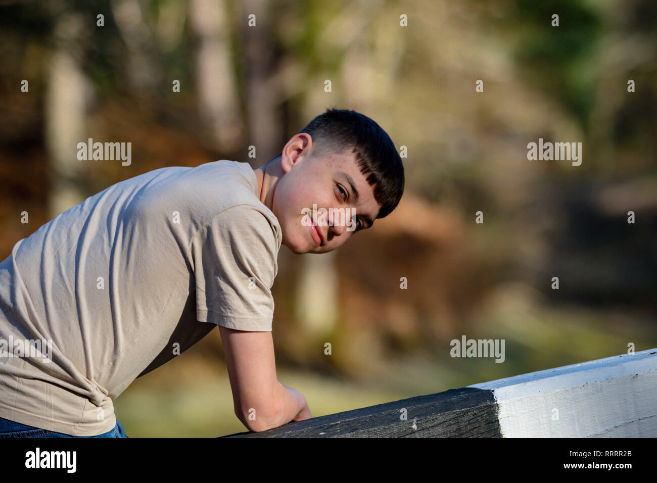 Portrait of a caucasian teenage boy on a warm spring day looking ...