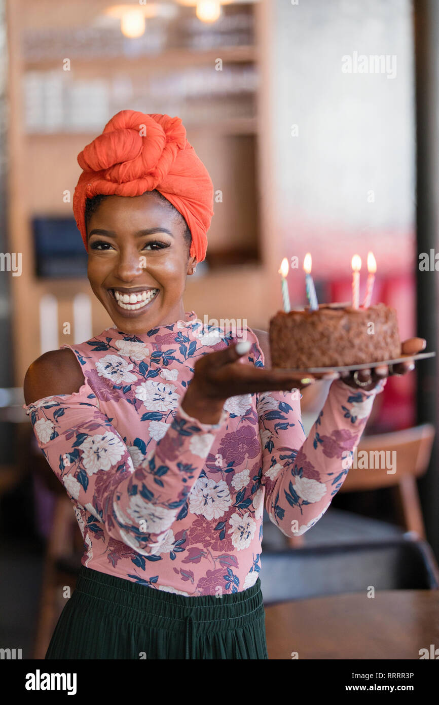 Portrait confident young woman carrying birthday cake Stock Photo - Alamy