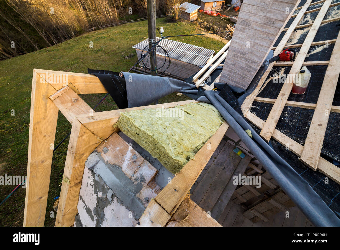 Roof construction and insulation with mineral wool. Wooden beams frame ...