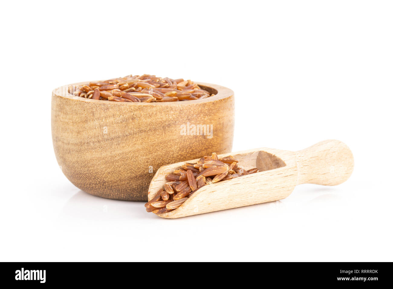 Lot of whole raw red rice in a scoop with wooden bowl isolated on white ...