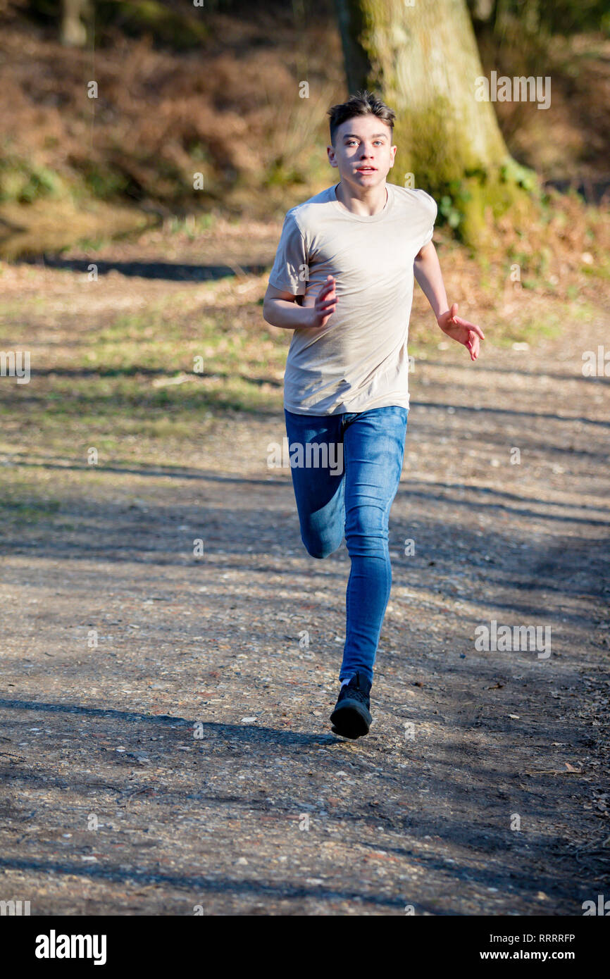 Caucasian teenage boy running on a warm spring day Stock Photo - Alamy