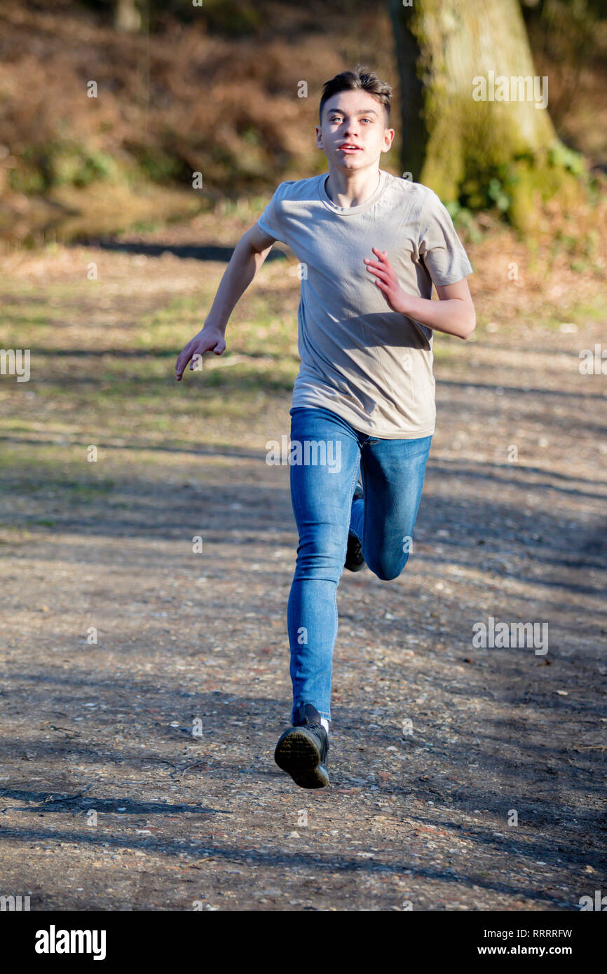 Caucasian teenage boy running on a warm spring day Stock Photo - Alamy