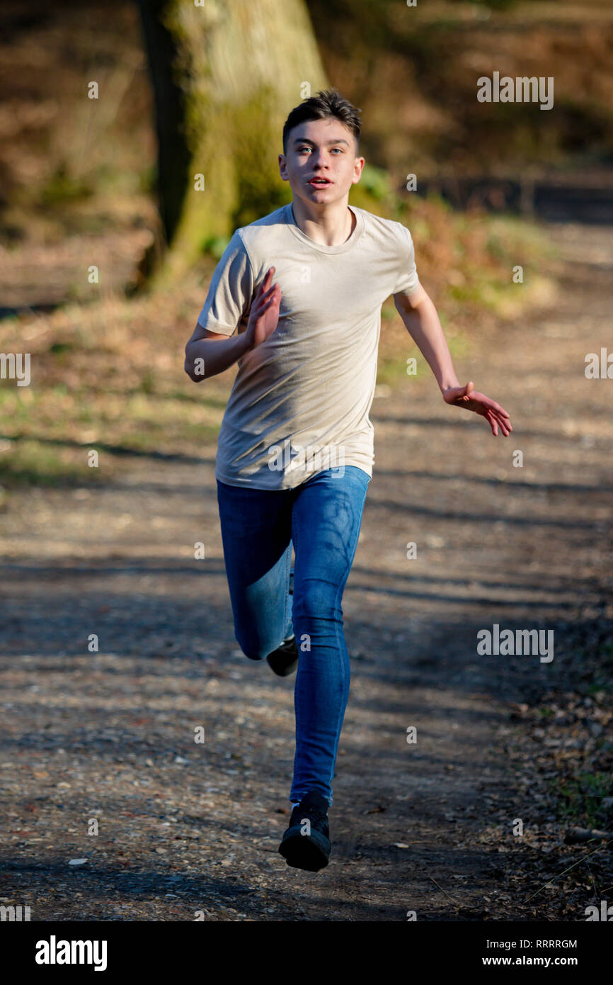 Caucasian teenage boy running on a warm spring day Stock Photo - Alamy