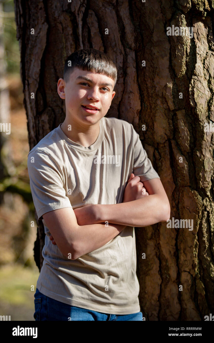 Kid leaning against tree hi-res stock photography and images - Alamy