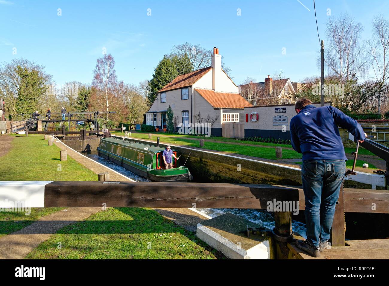 A narrow boat passing through the Thames lock which connects the River ...
