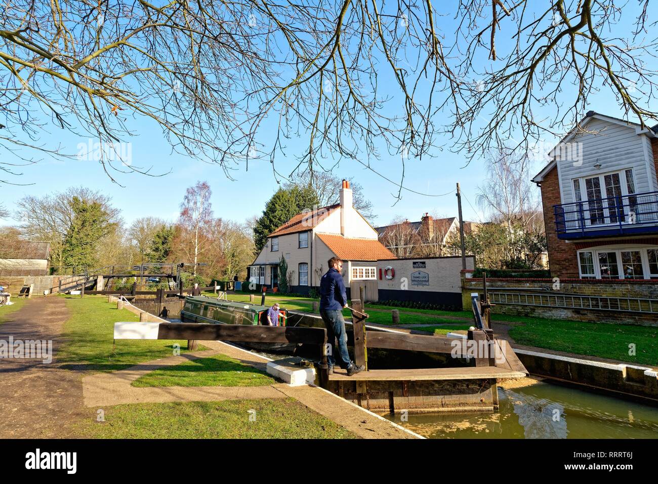 A narrow boat passing through the Thames lock which connects the River ...