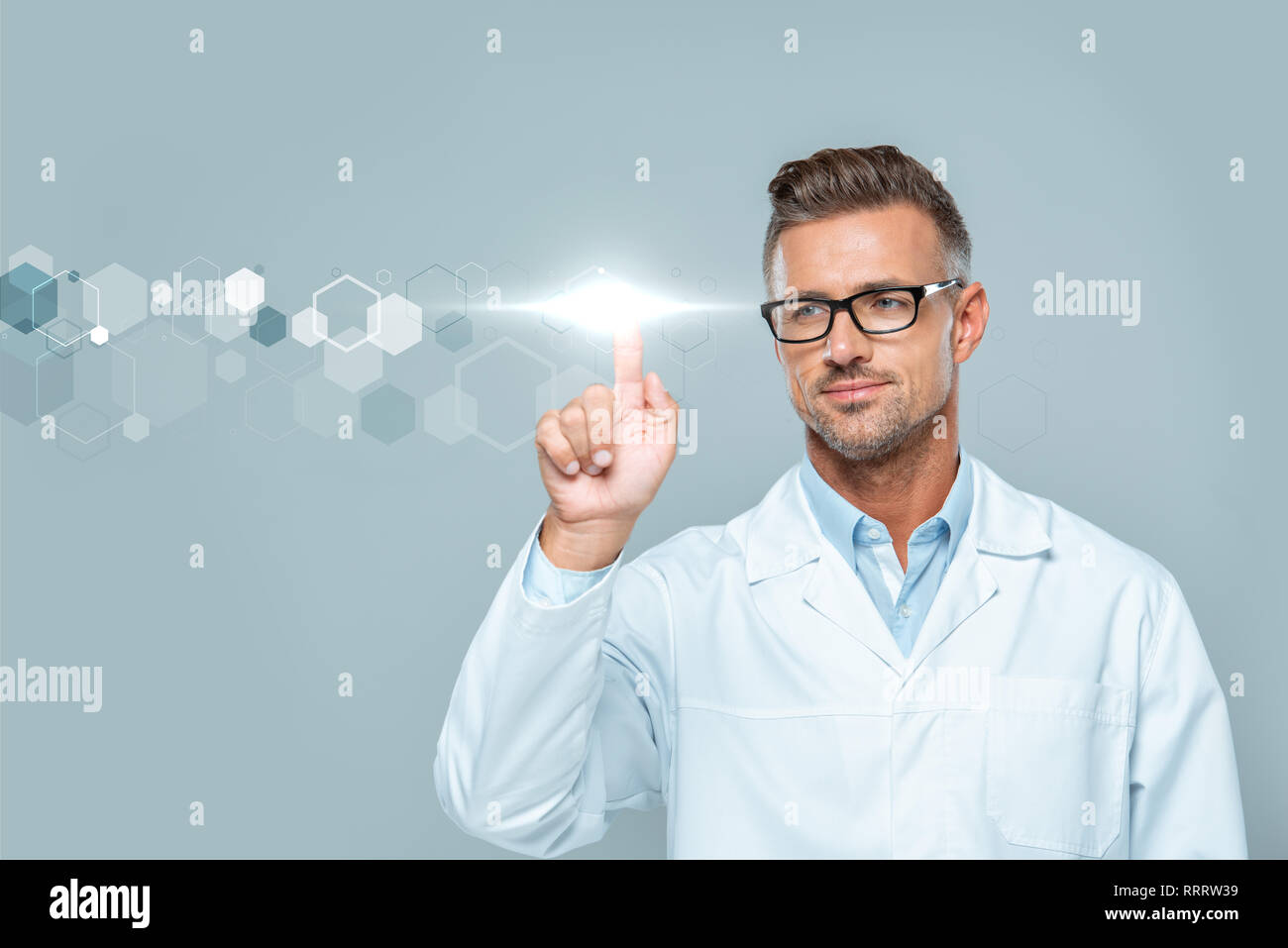 handsome scientist in white coat and glasses touching technology ...