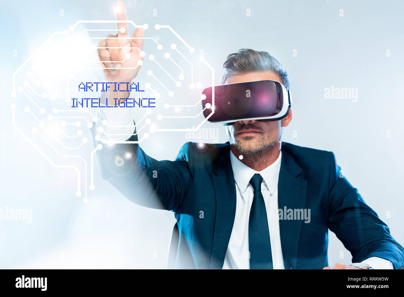 businessman in virtual reality headset touching brain isolated on white ...