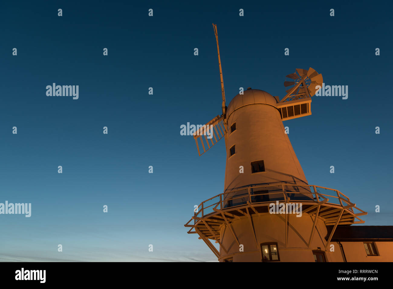 windmill with blue background dramatic light sky Stock Photo - Alamy