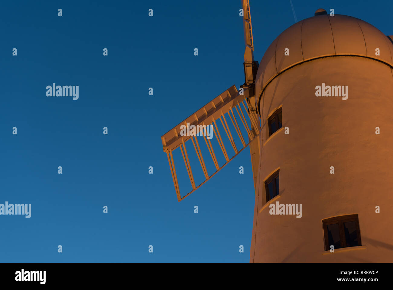 windmill with blue background dramatic light sky Stock Photo - Alamy