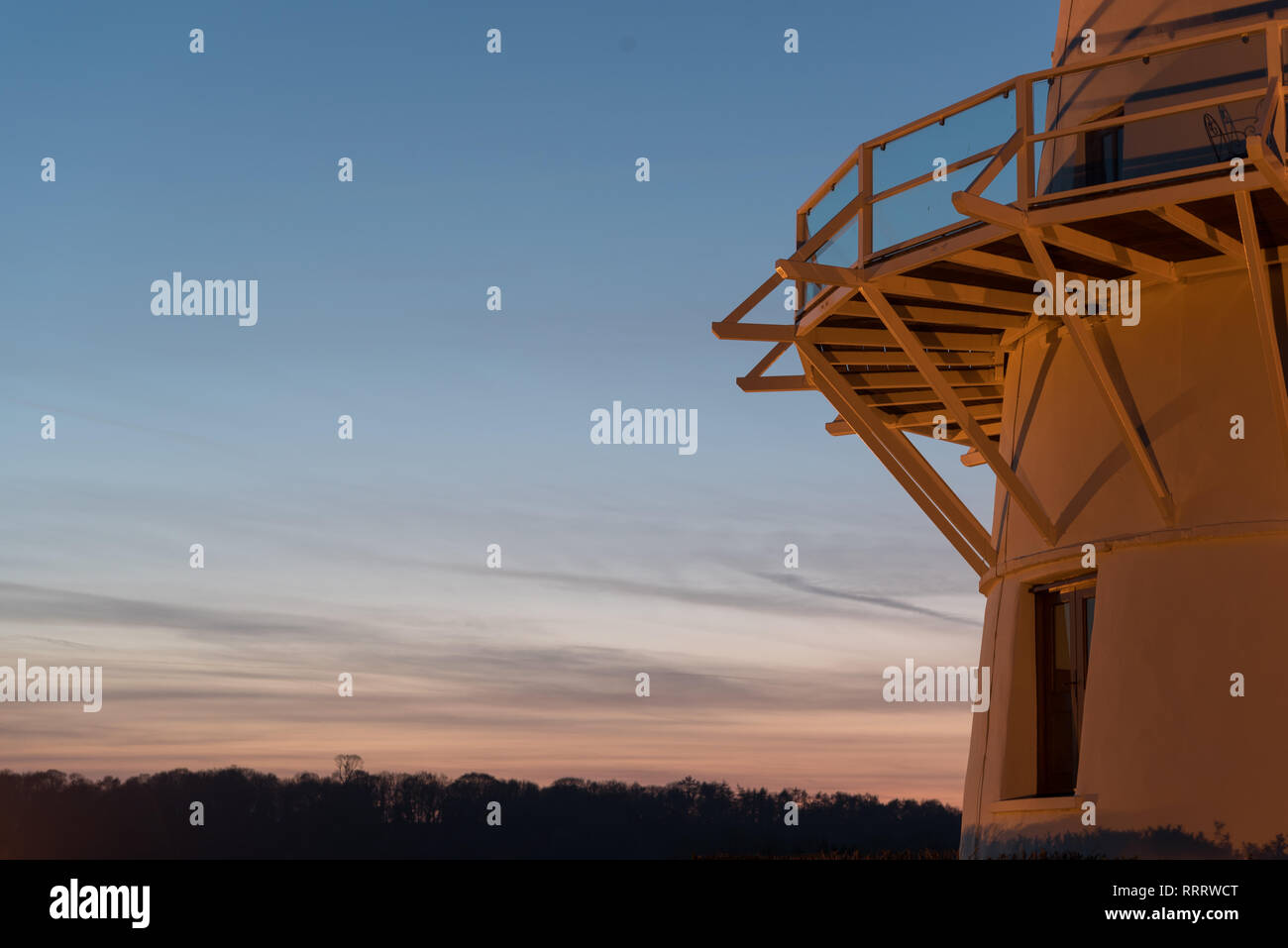 windmill with blue background dramatic light sky Stock Photo - Alamy
