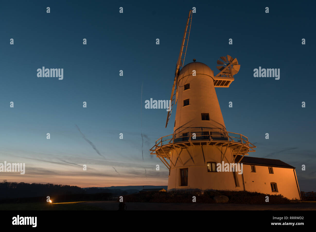 windmill with blue background dramatic light sky Stock Photo - Alamy