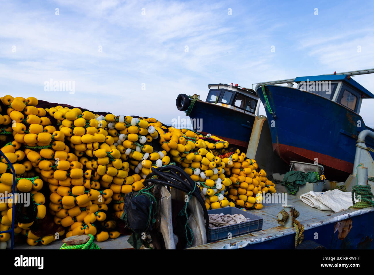 Fishing net stack on the fishing boat Stock Photo - Alamy