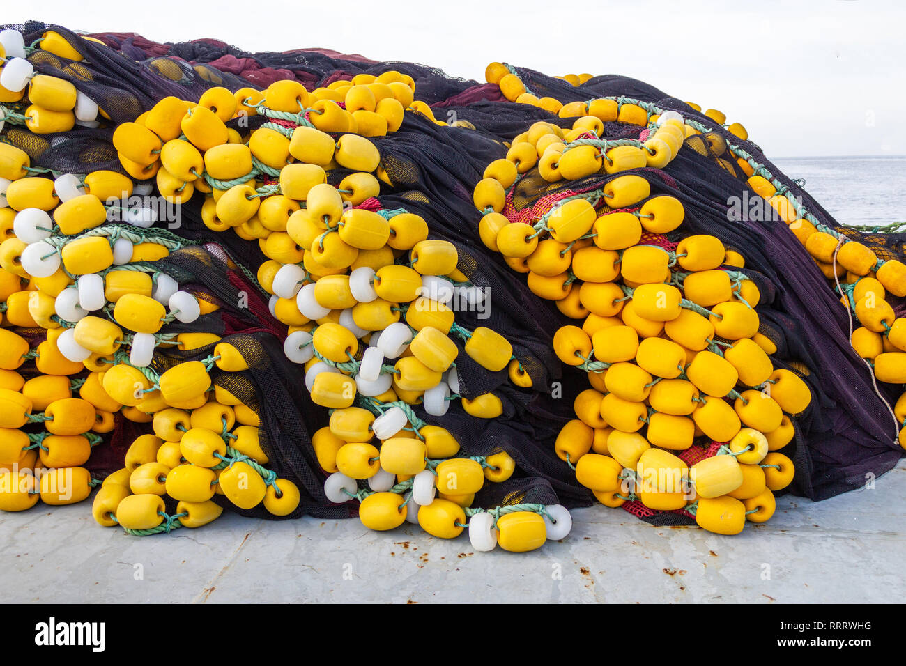 Fishing net stack on the fishing boat Stock Photo - Alamy