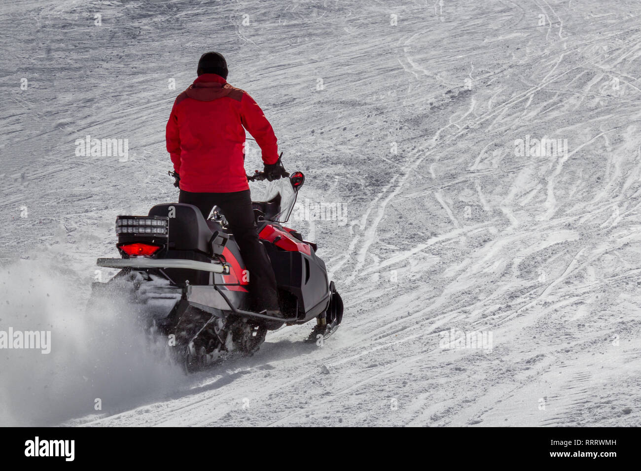 Man driving a snowmobile Stock Photo - Alamy