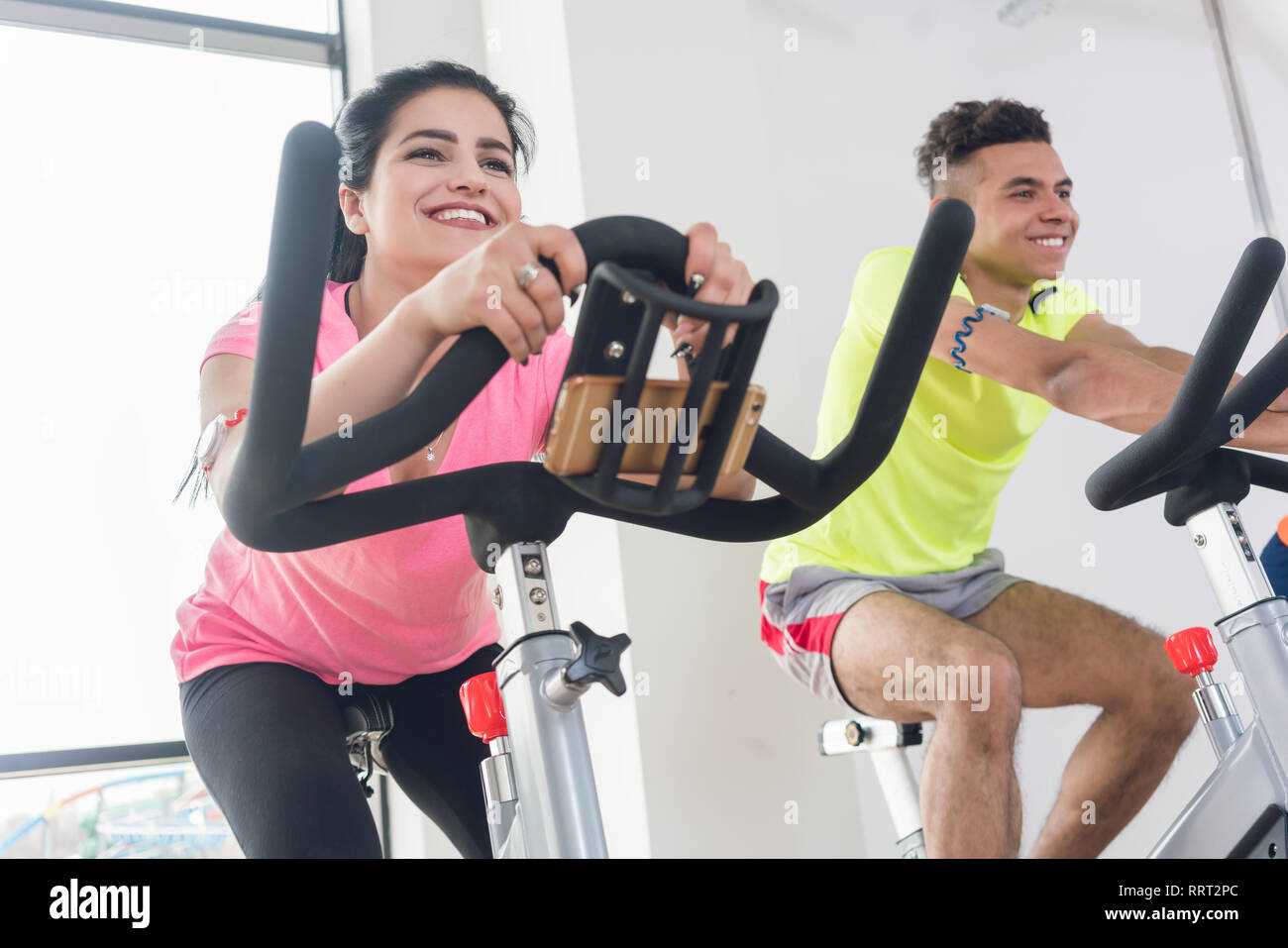 Two friends cycling at gym Stock Photo - Alamy