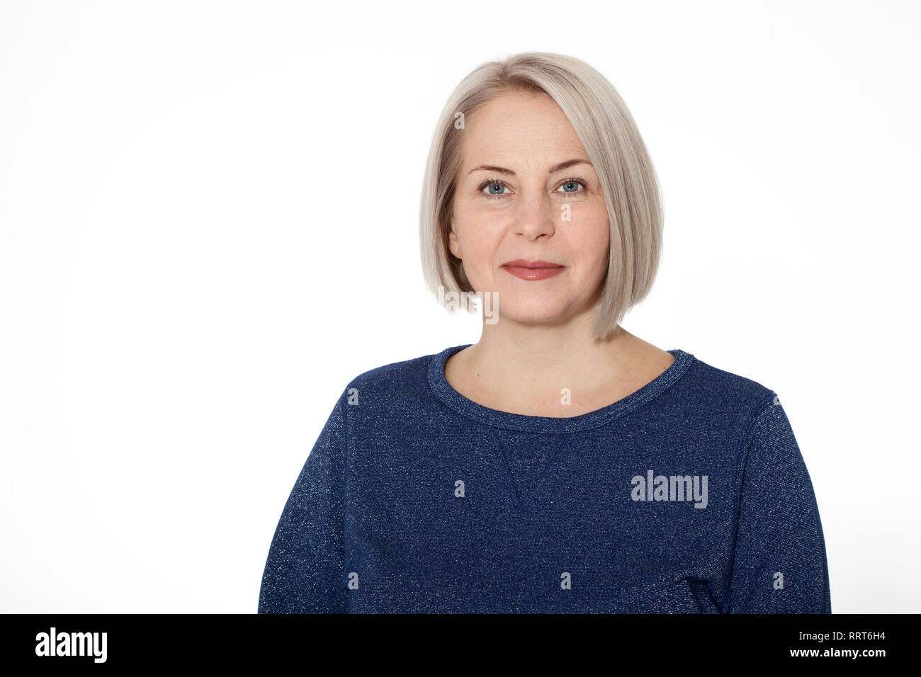 Attractive middle aged woman with folded arms emotionally posing in studio on white background ...