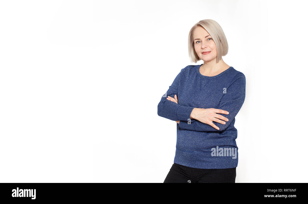 Attractive middle aged woman with folded arms emotionally posing in studio on white background ...
