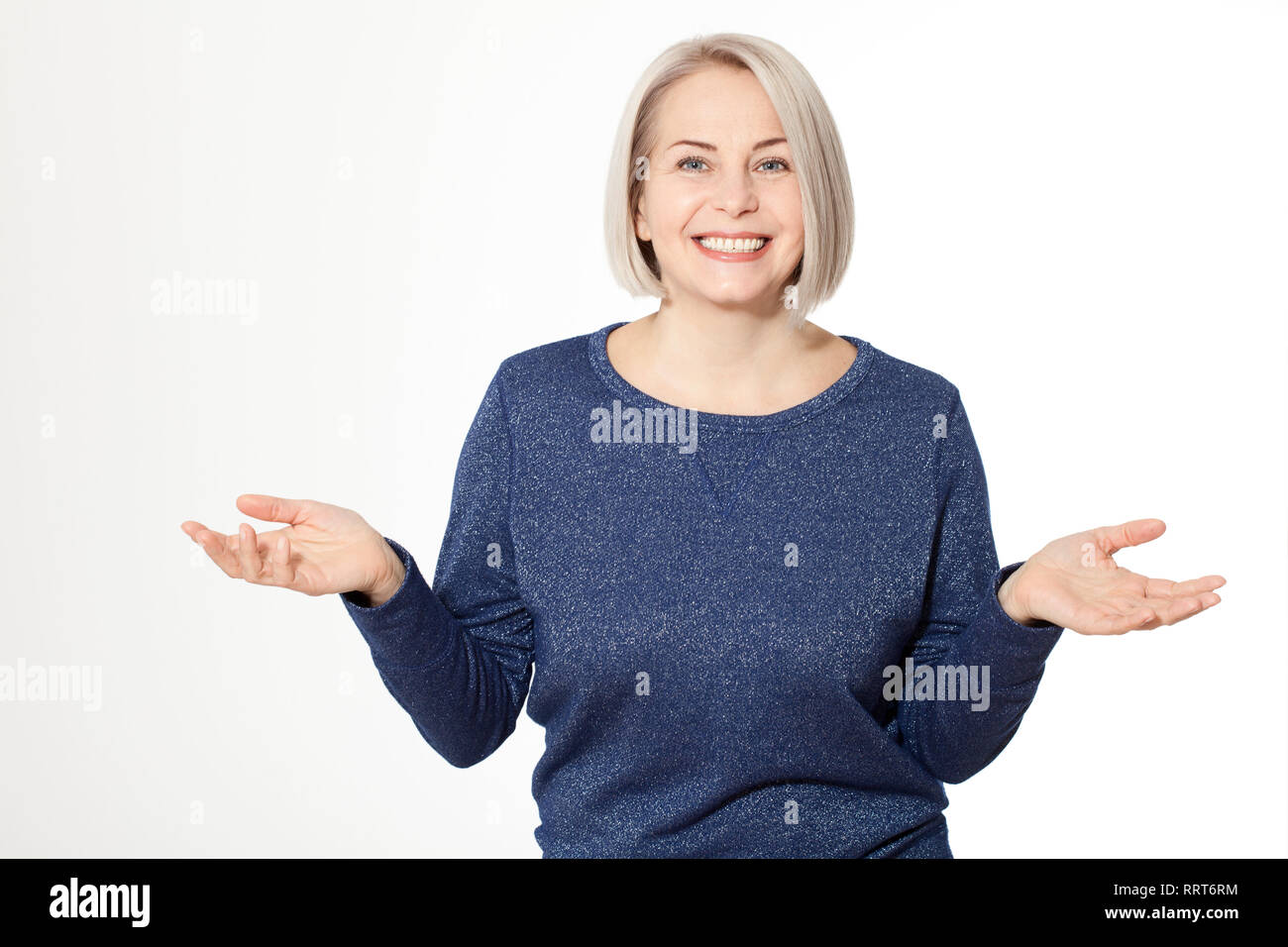 Attractive middle aged woman with folded arms emotionally posing in studio on white background ...