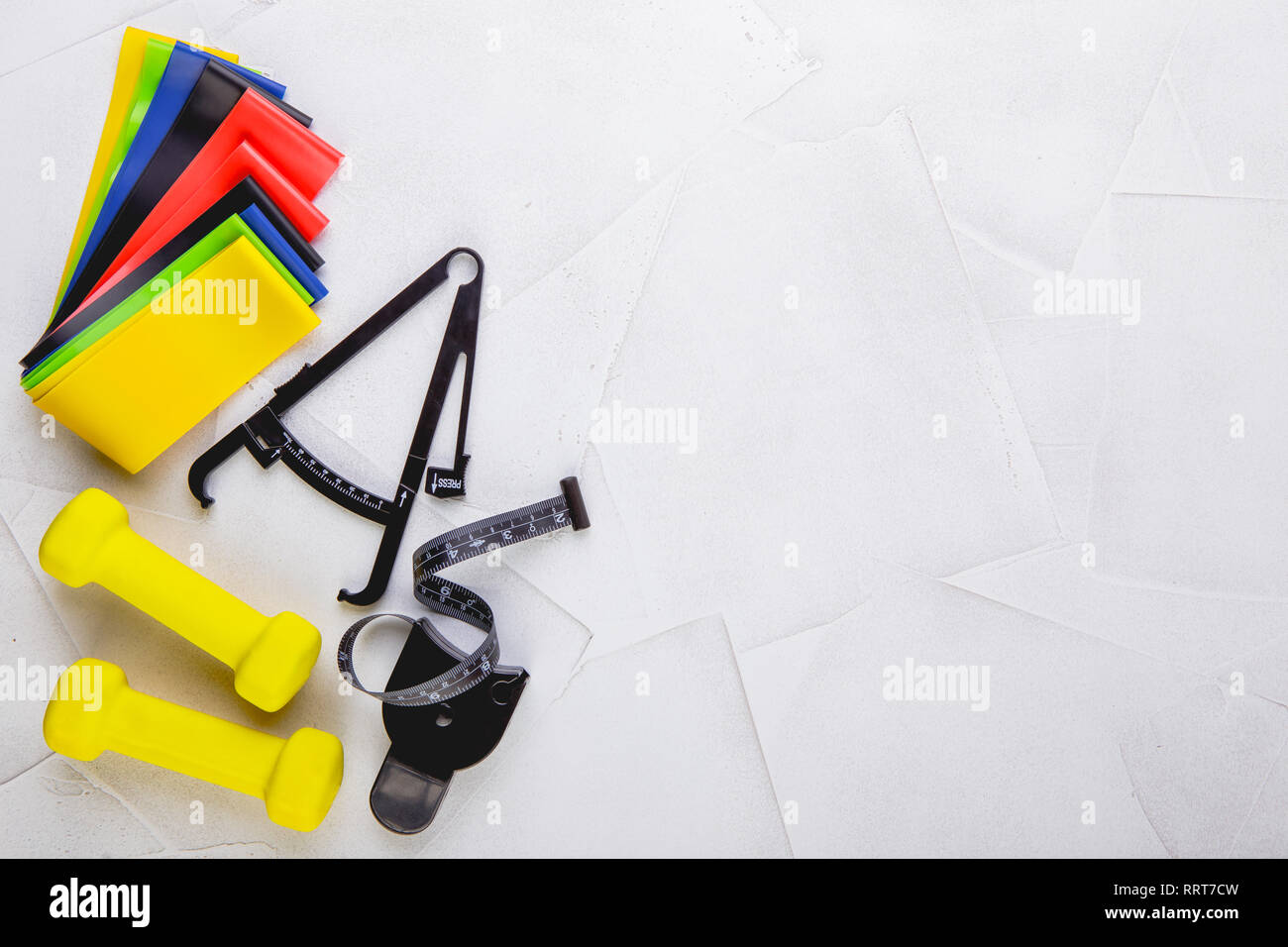 Top view image of dumbbells, colorful elastic gum expanders, calipers ...