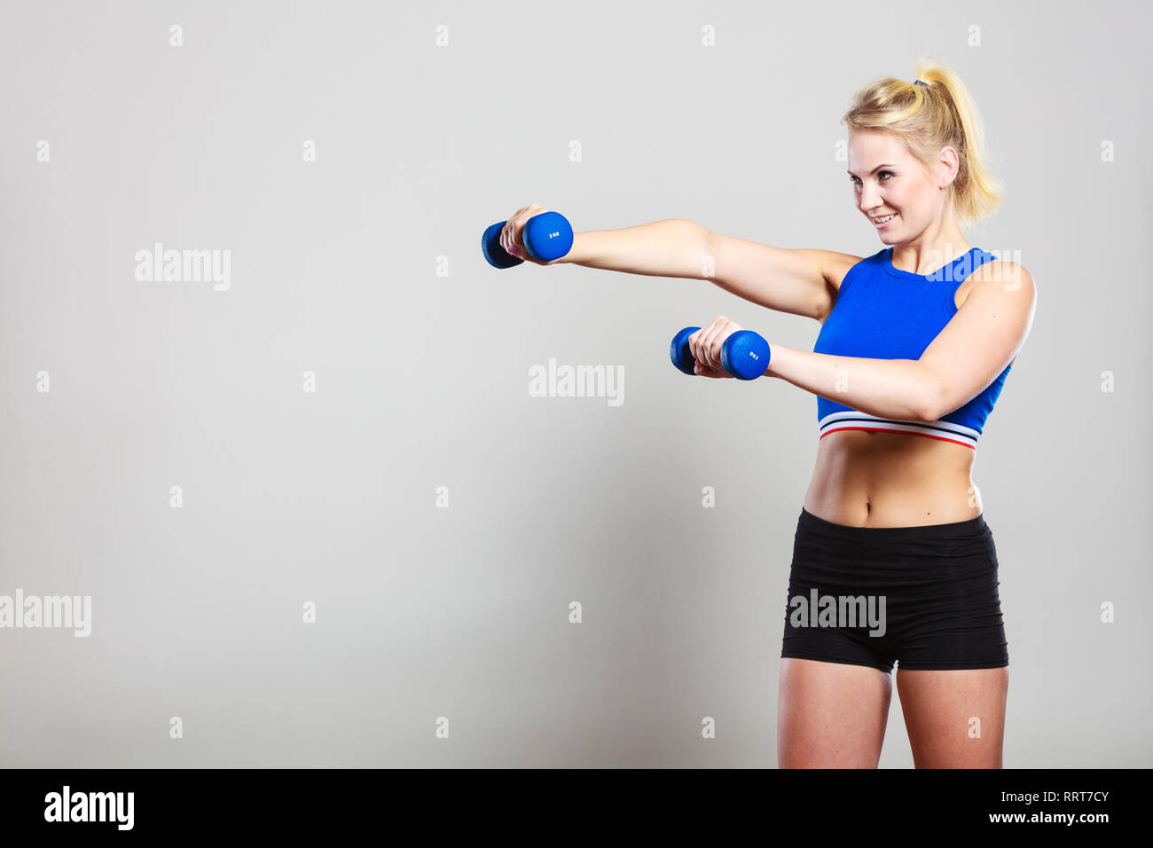 Sporty woman lifting light dumbbells weights. Fit girl exercising ...