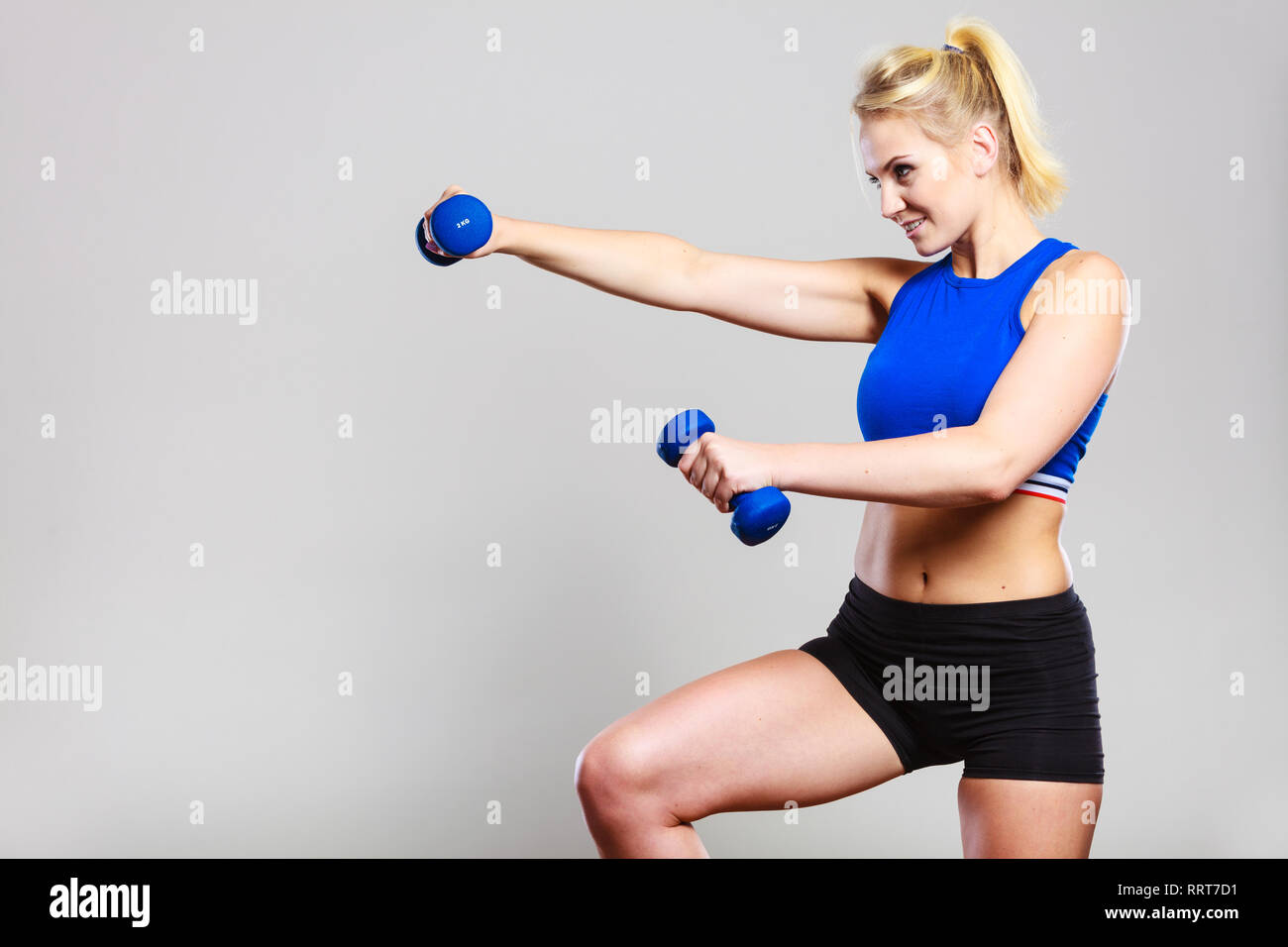 Sporty woman lifting light dumbbells weights. Fit girl exercising ...