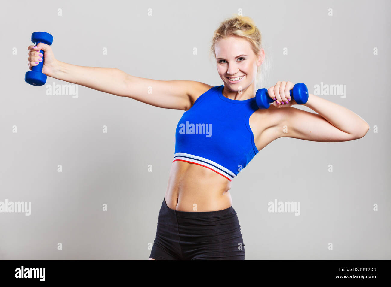 Sporty woman lifting light dumbbells weights. Fit girl exercising ...