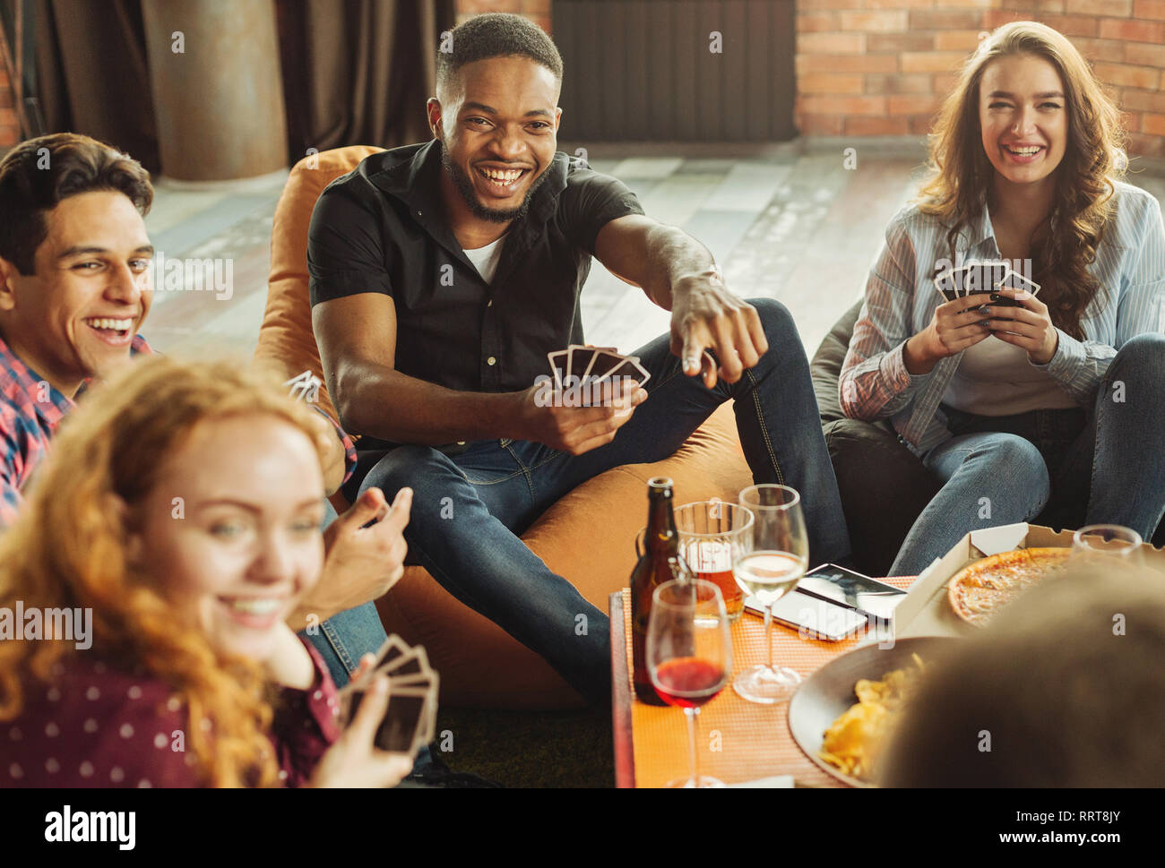 Friends playing cards Stock Photo - Alamy