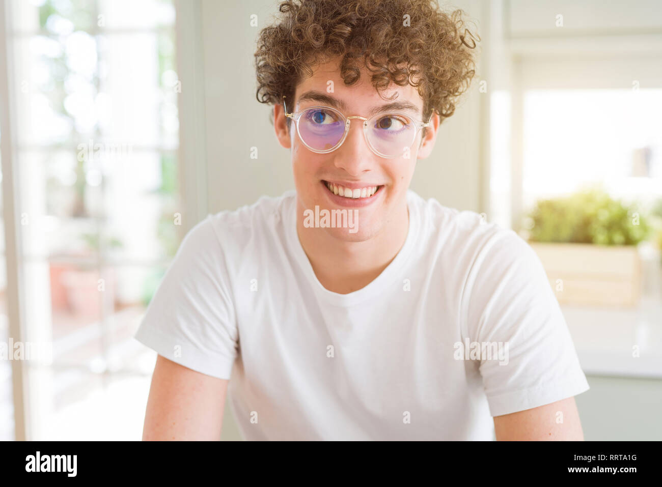 Young handsome man wearing glasses smiling looking side and staring ...