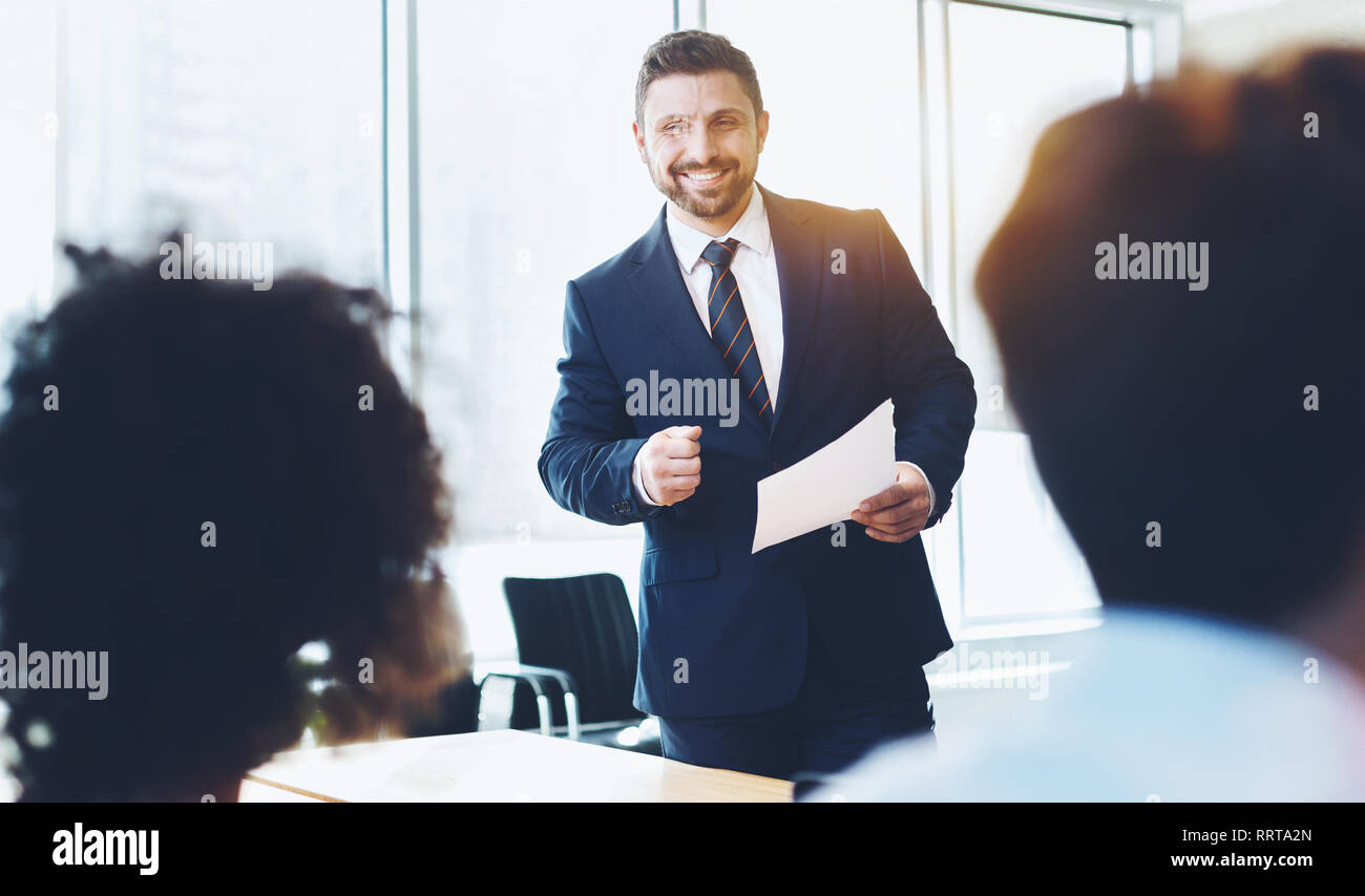 Business coach speaking to young people at training seminar Stock Photo ...